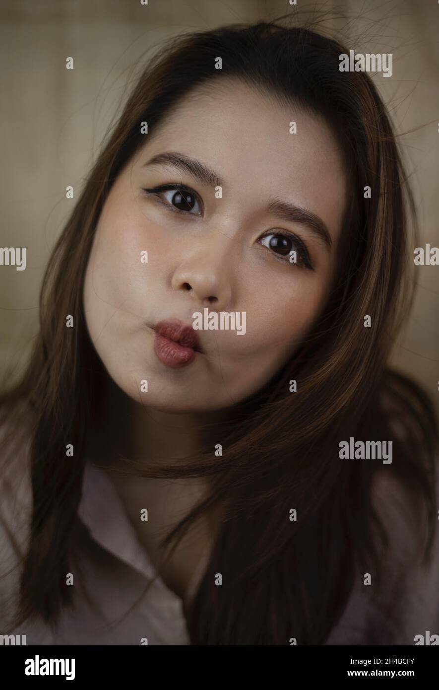 Cute Vietnamese lady making a funny facial gesture Stock Photo - Alamy
