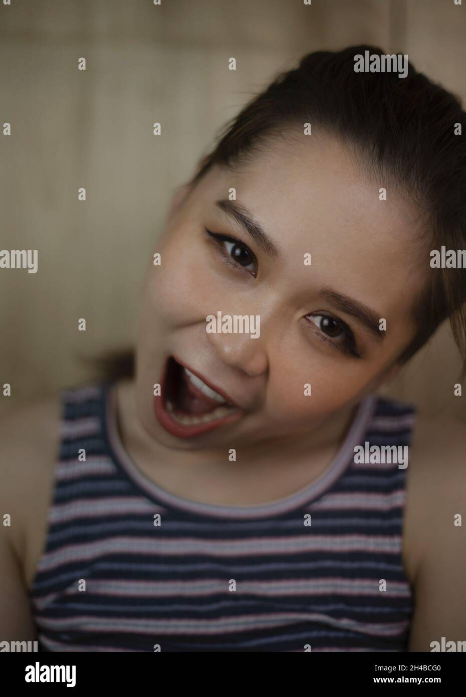 Cute Vietnamese lady making a funny facial gesture Stock Photo - Alamy