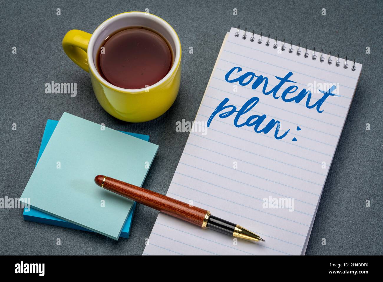 content plan writing in a notebook with a cup of tea, content strategy ...