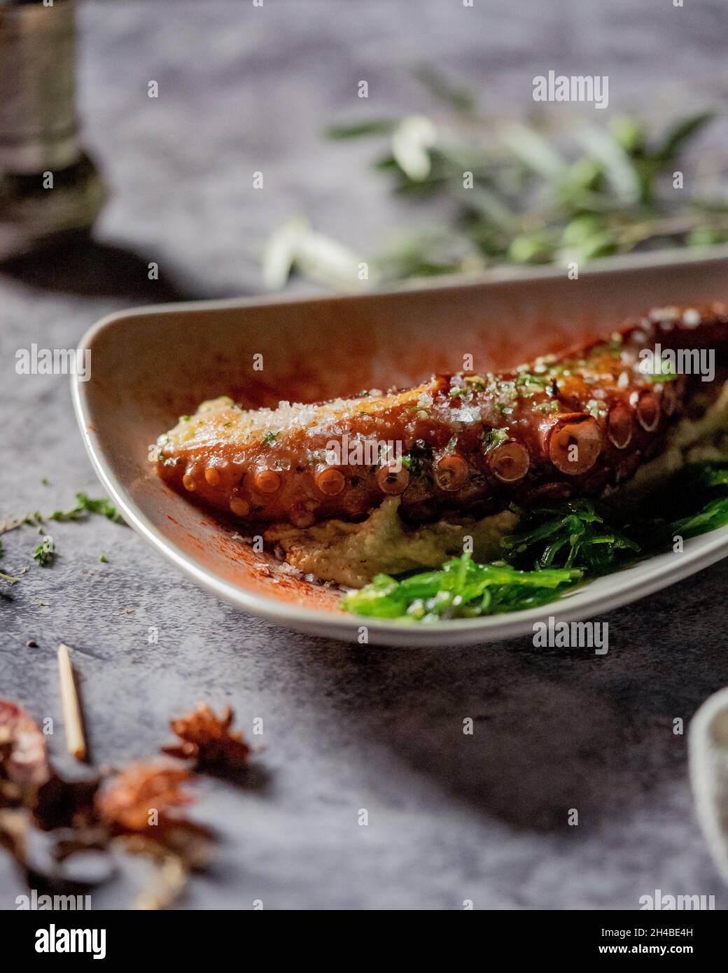 Oval-shaped bowl containing seafood and vegan food in a restaurant ...