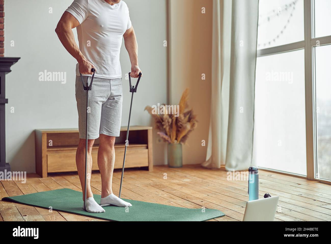 Athletic man exercising at home with outfit and notebook Stock Photo ...