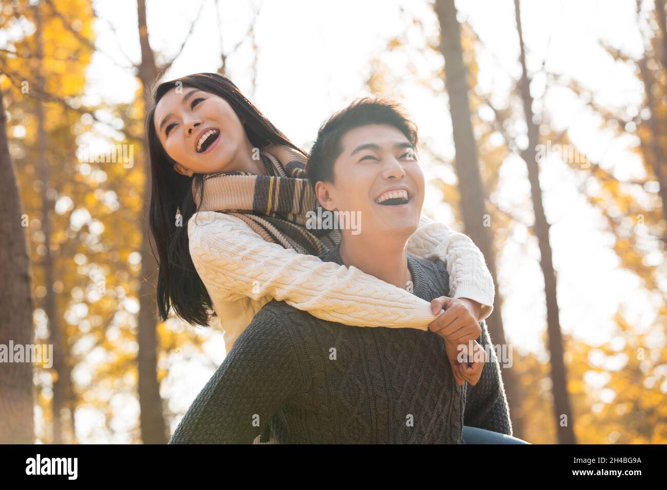 Asian man carrying girlfriend piggyback hi-res stock photography and ...