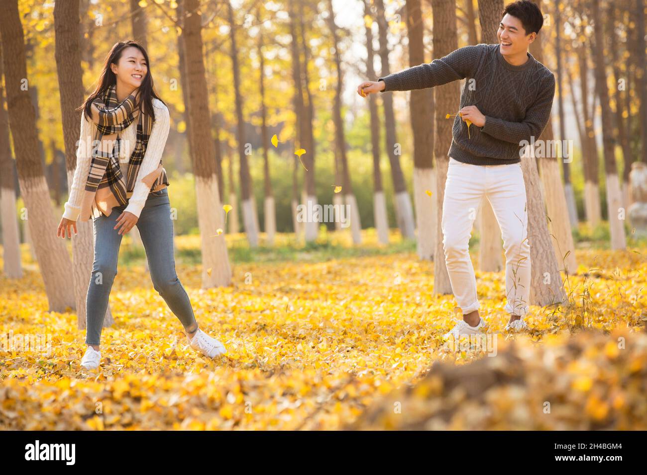 Happy young lovers frolicking in the woods Stock Photo - Alamy