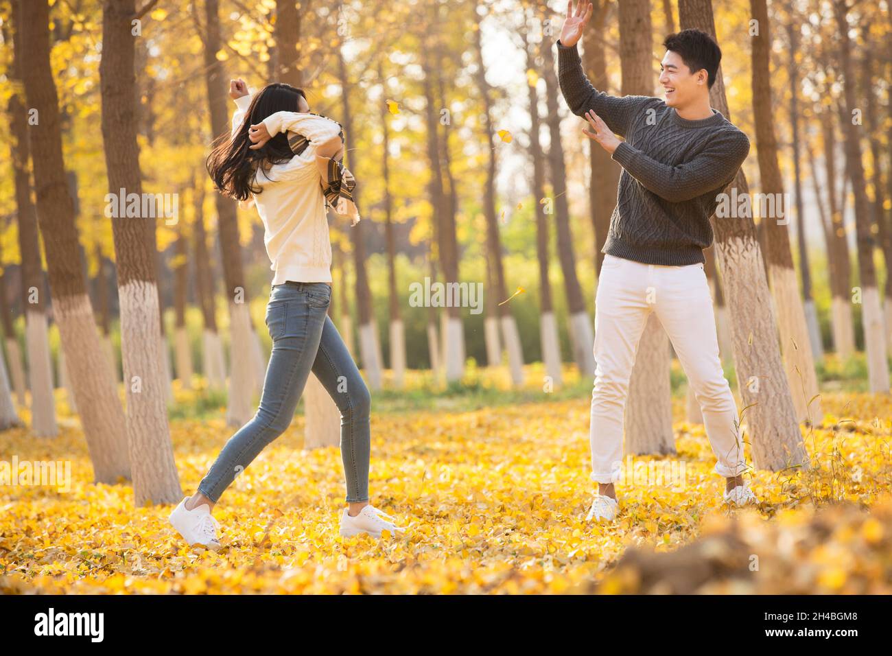 Happy young lovers frolicking in the woods Stock Photo - Alamy