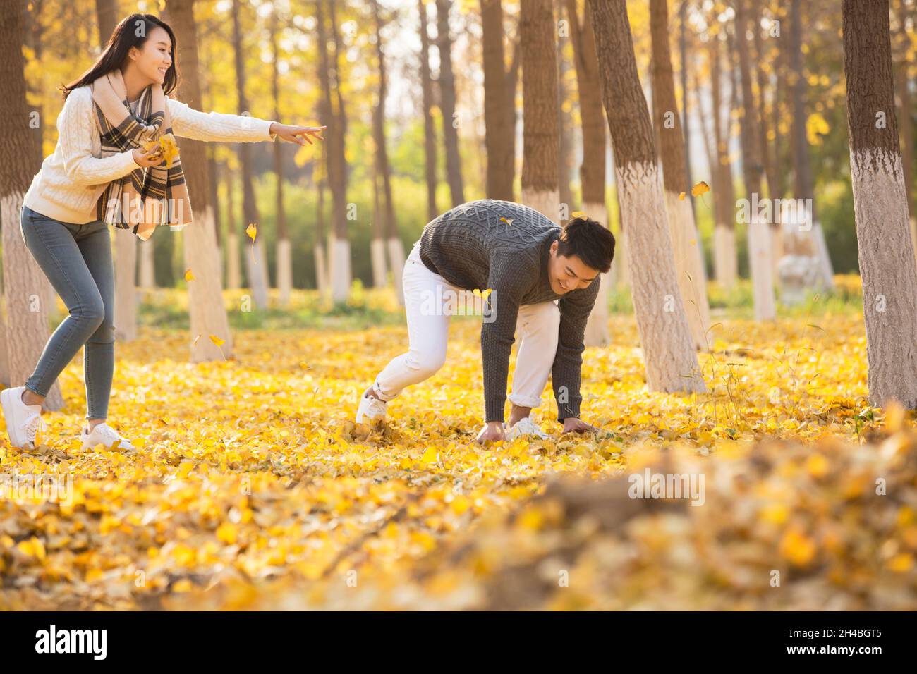 Happy young lovers frolicking in the woods Stock Photo - Alamy
