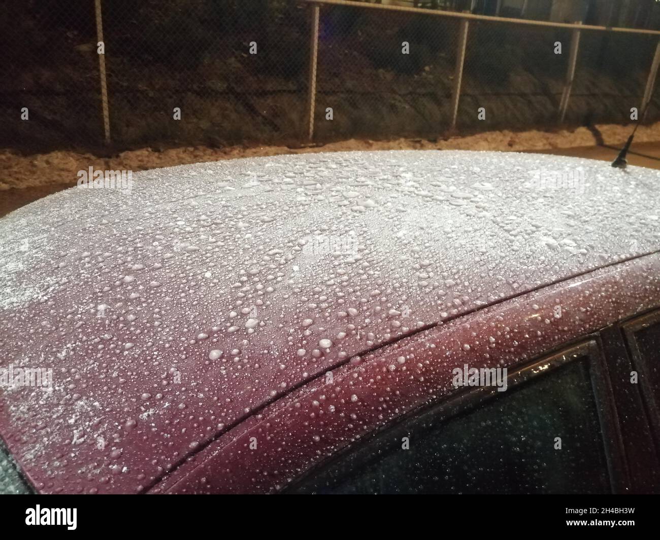 Top of a red car frozen by extremely cold weather Stock Photo - Alamy