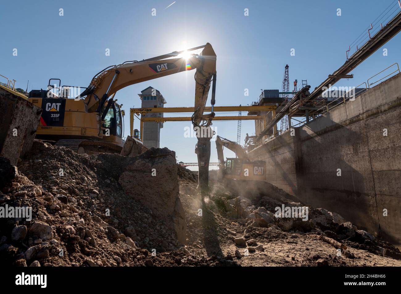 Hydraulic excavators with hoe rams go to work as the U.S. Army Corps of ...