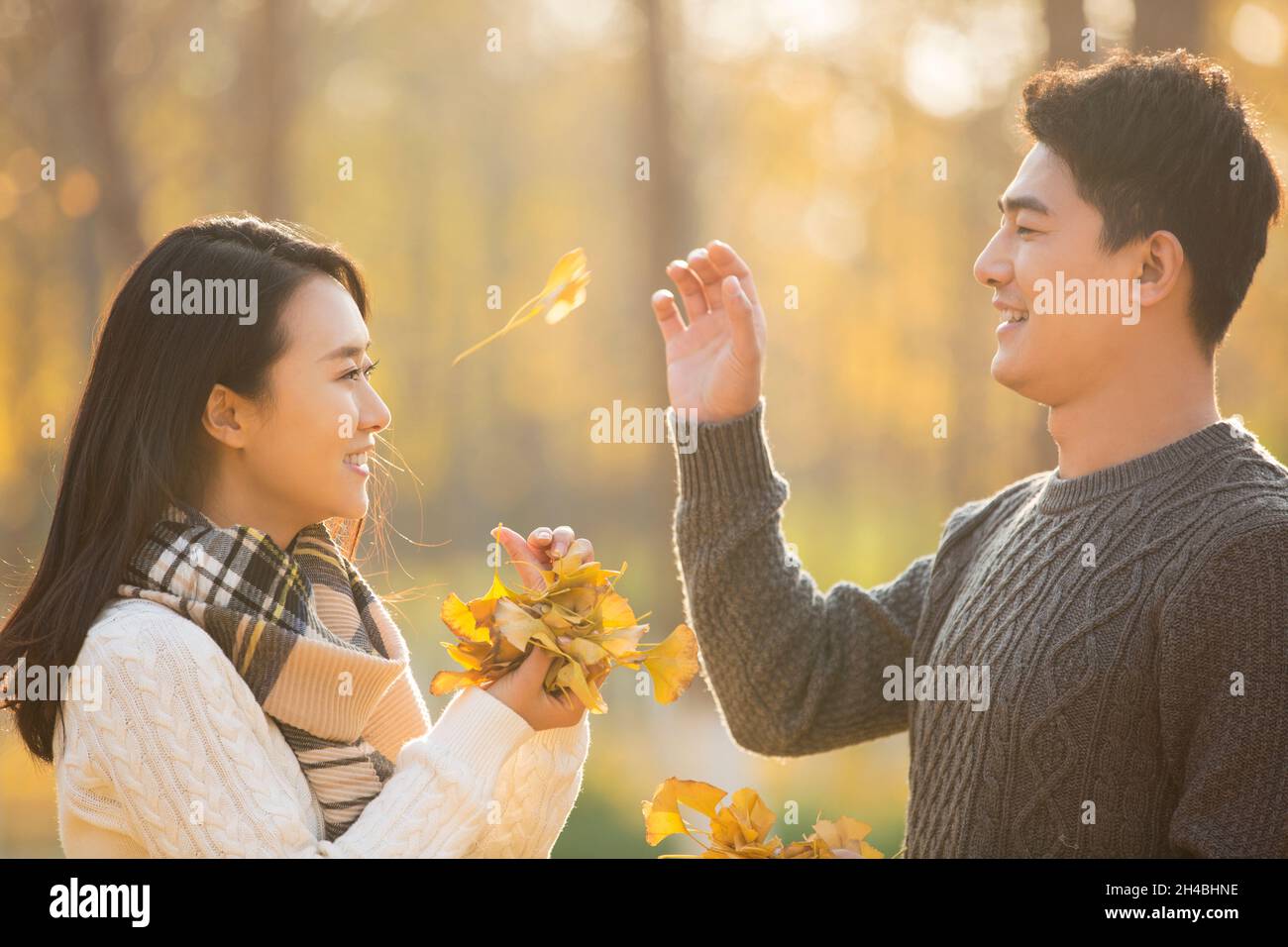 Happy young lovers playing in the woods Stock Photo - Alamy