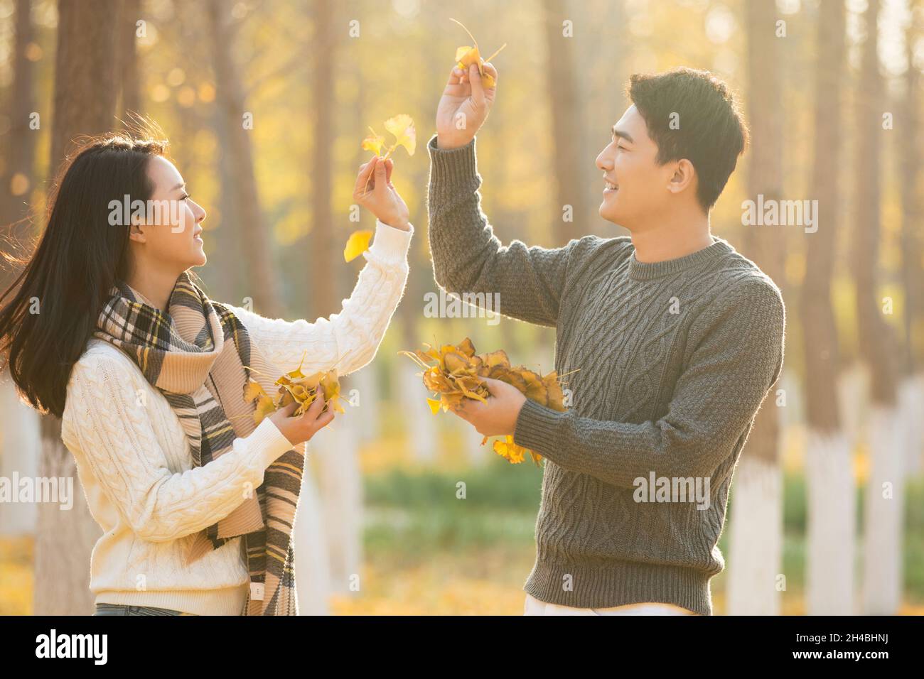 Happy young lovers playing in the woods Stock Photo - Alamy