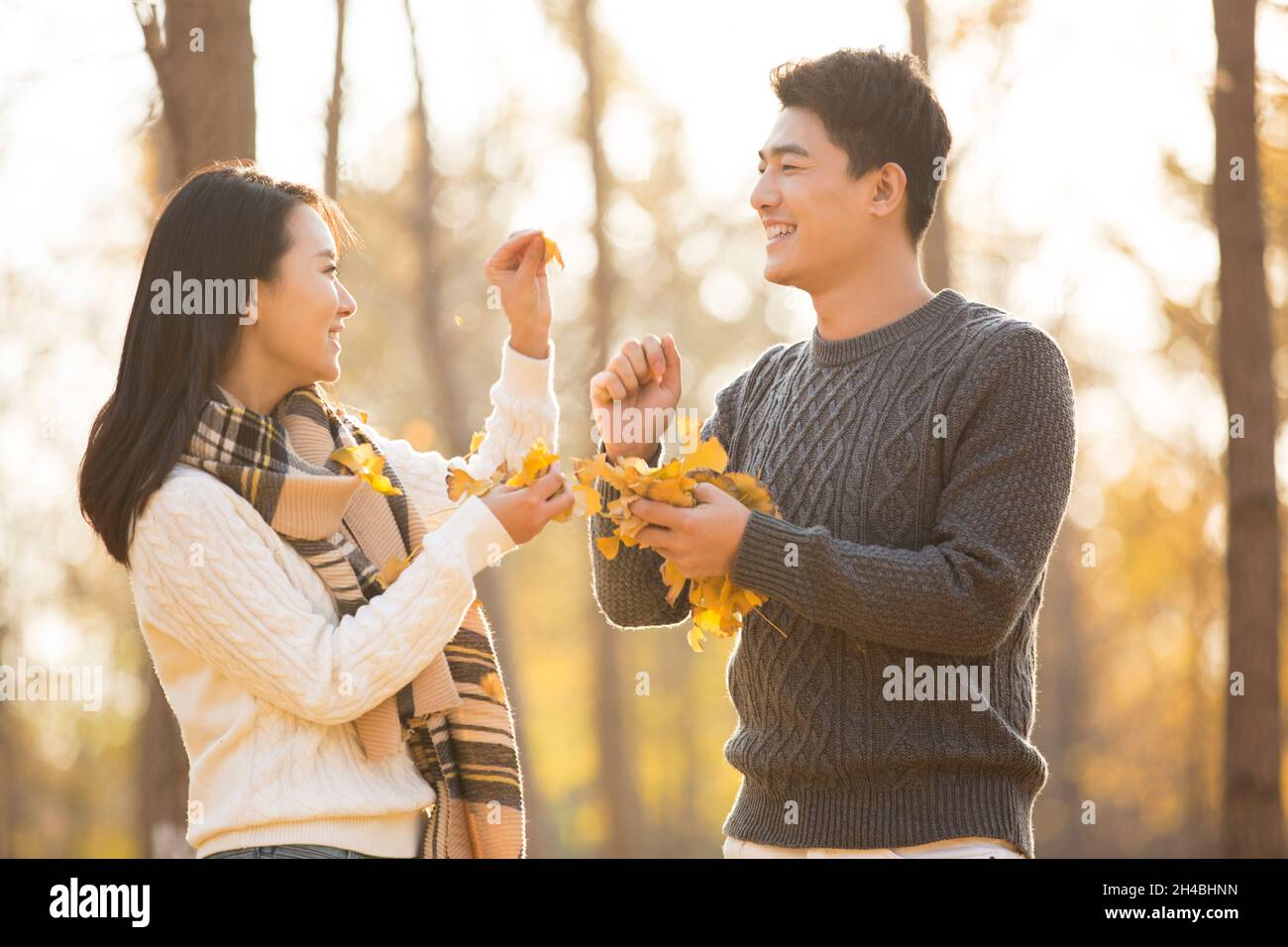 Happy young lovers playing in the woods Stock Photo - Alamy