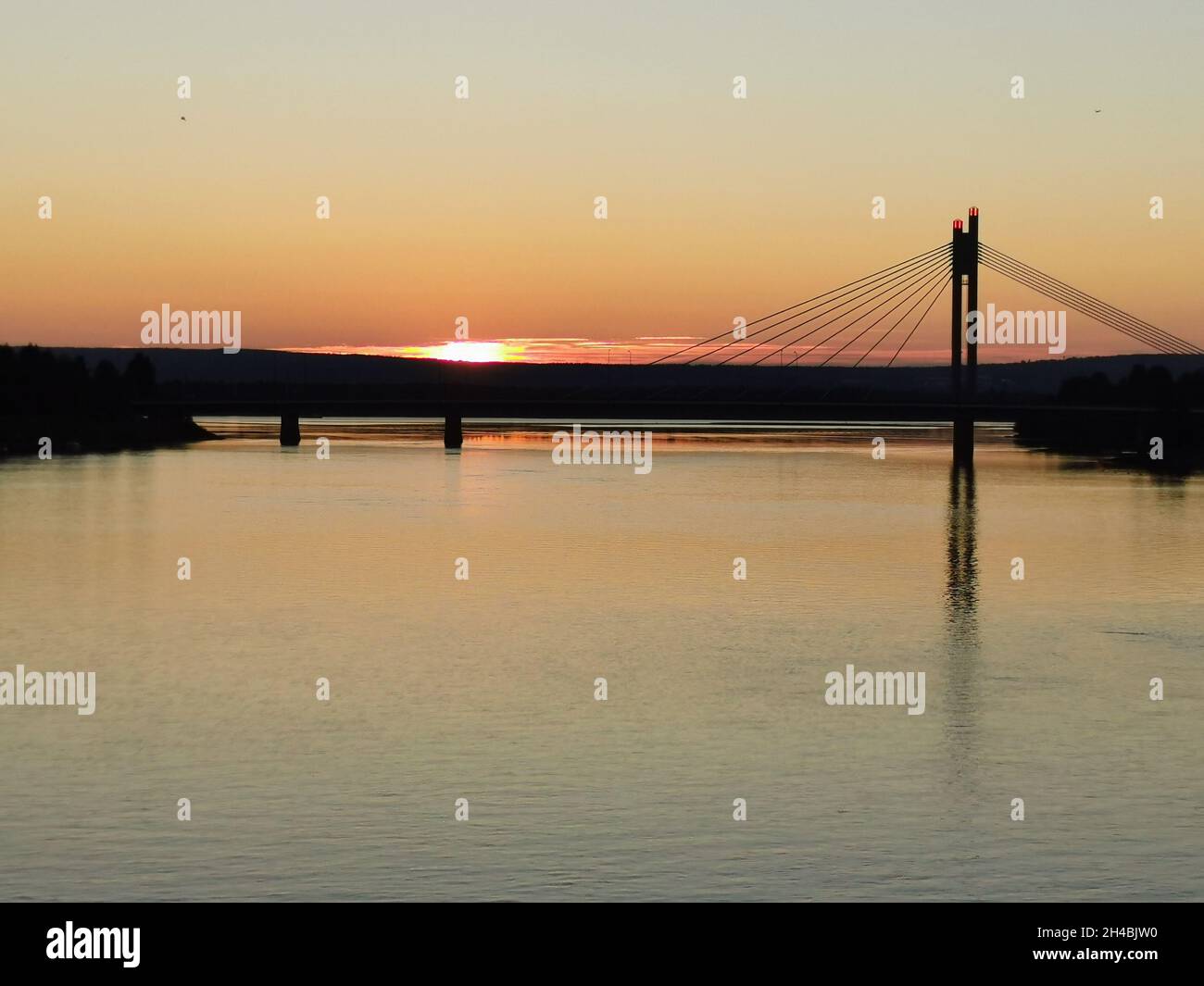 A bridge side view on a river background of a purple sunset Stock Photo ...