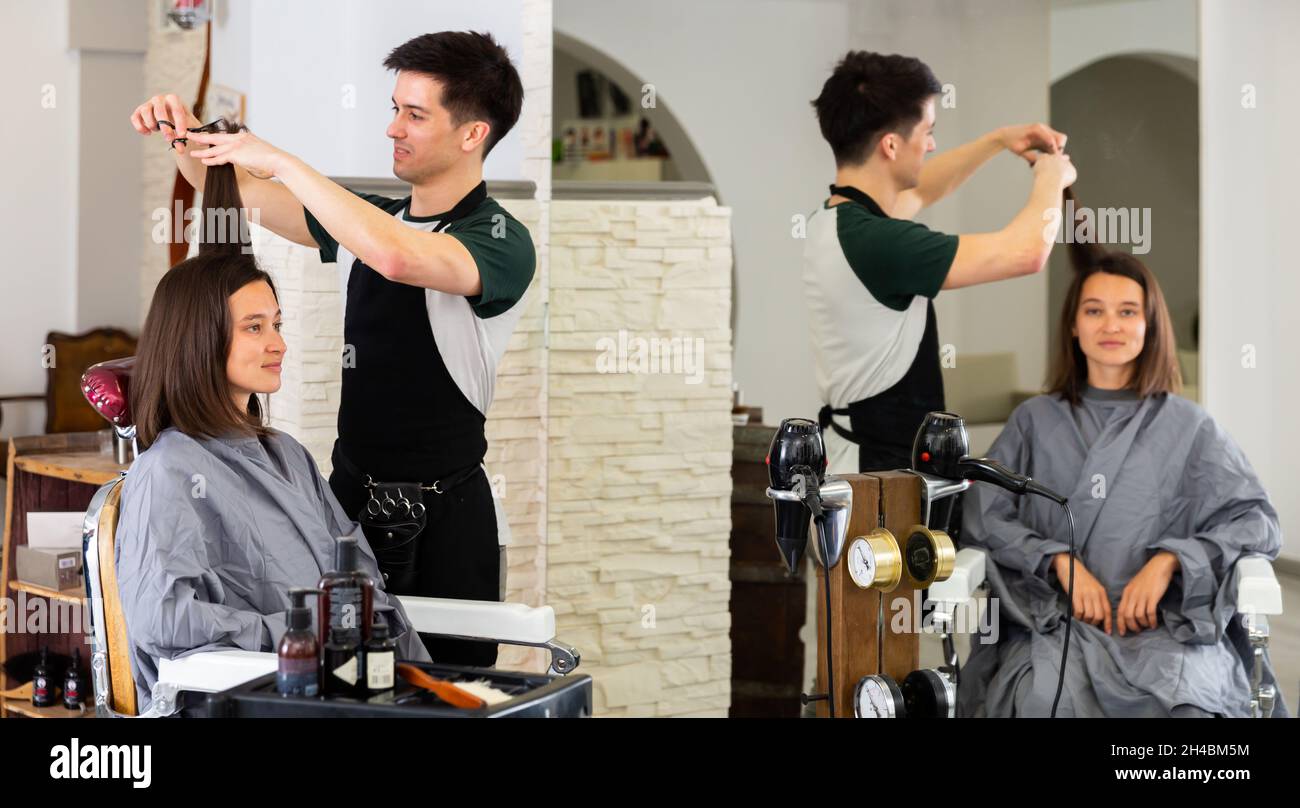 Man professional hairdresser cut female's hair in salon Stock Photo - Alamy