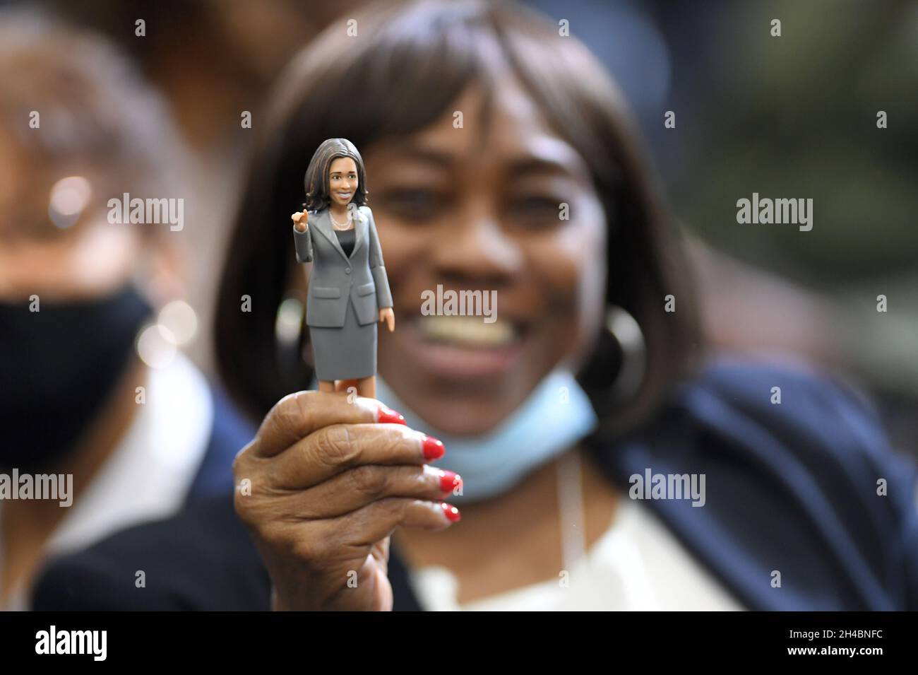 New York City Council Member Margaret Denson holds up a figurine of U.S ...