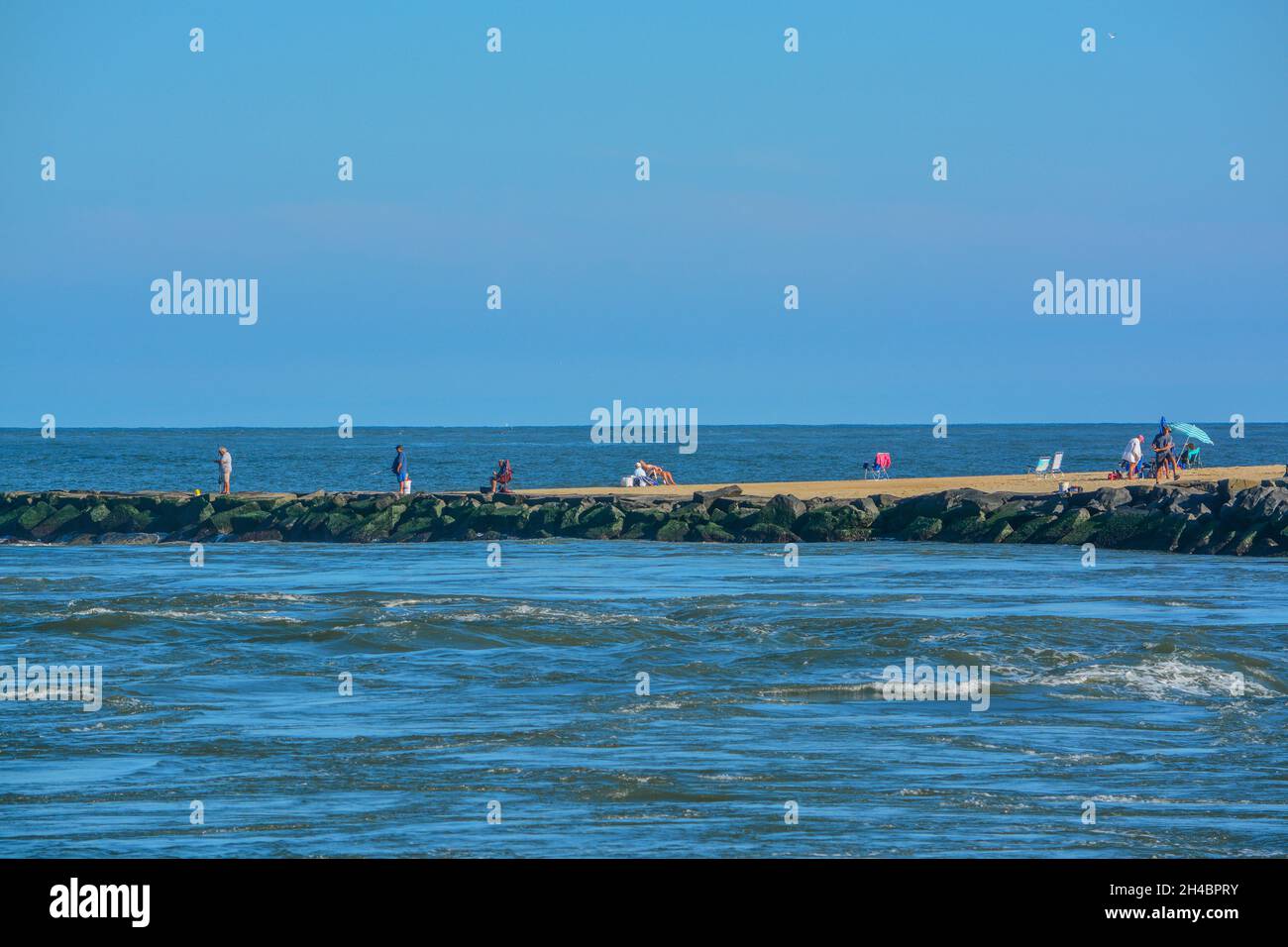 The Indian River Inlet flowing past the jetty on the Atlantic Ocean. At ...