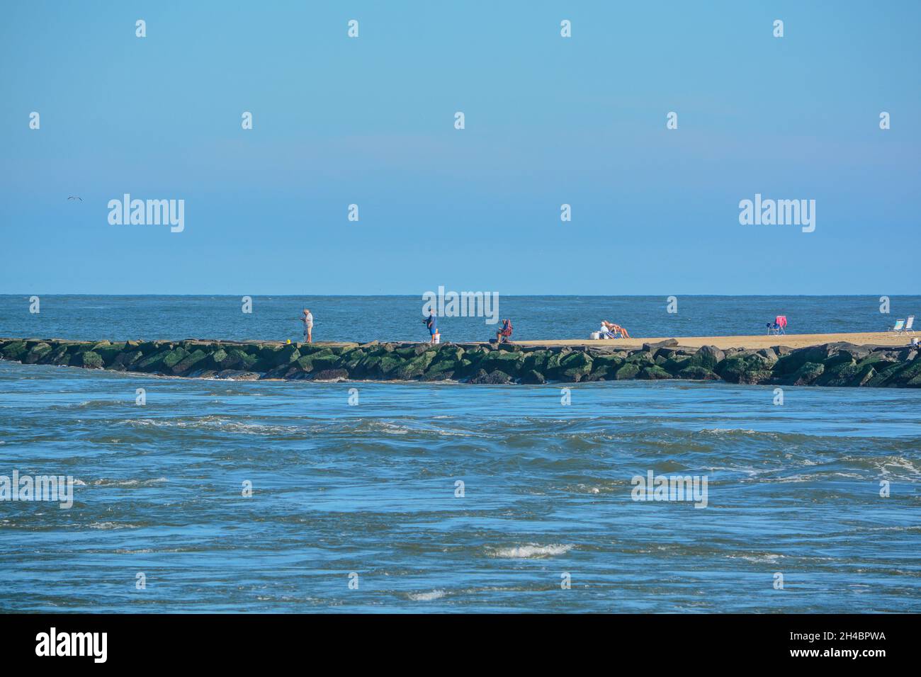 The Indian River Inlet flowing past the jetty on the Atlantic Ocean. At ...