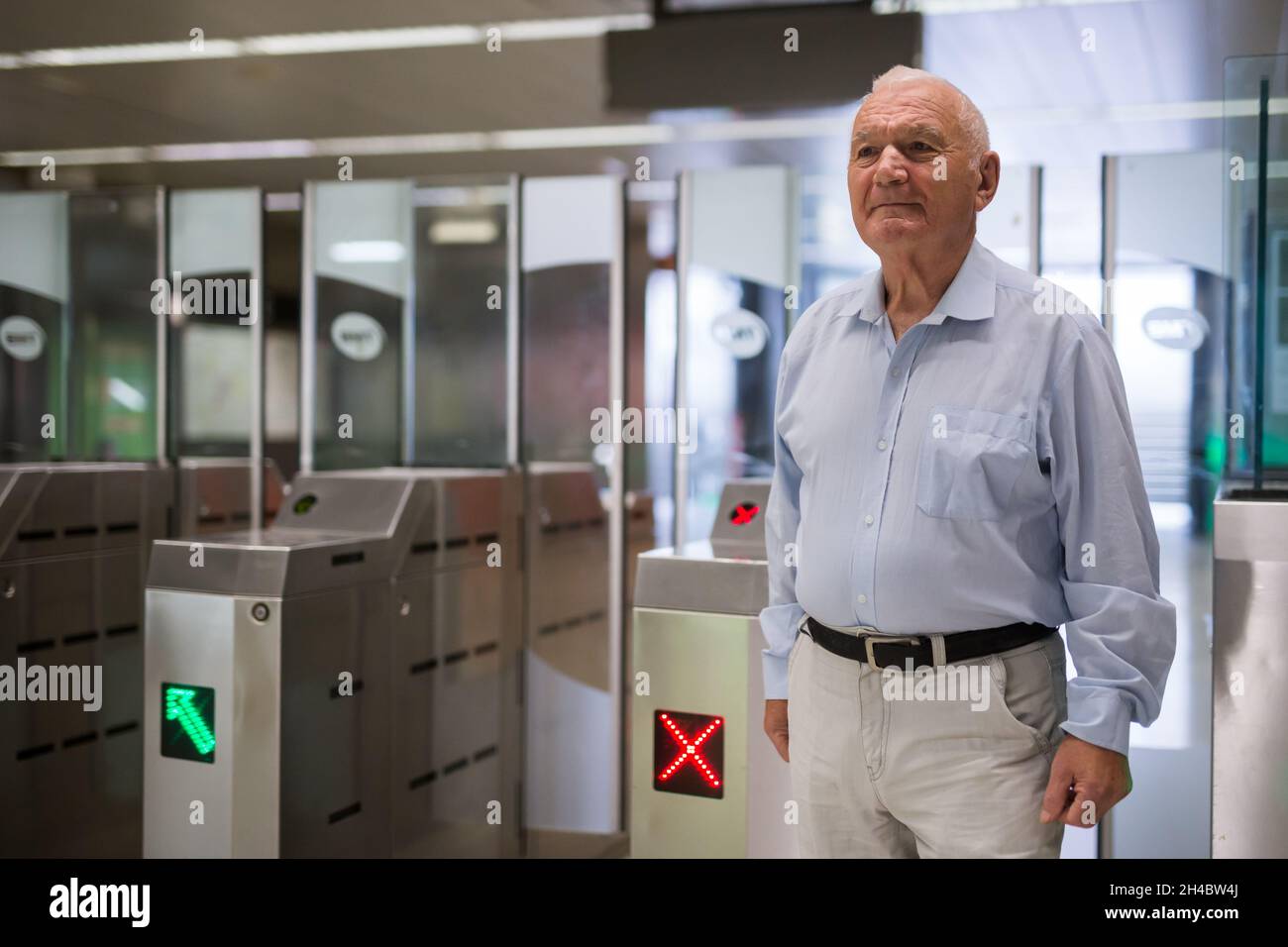 Old man entering subway station Stock Photo - Alamy