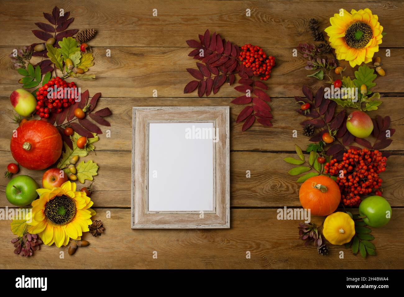 Wooden small frame mockup with sunflowers, pumpkins and fall leaves ...