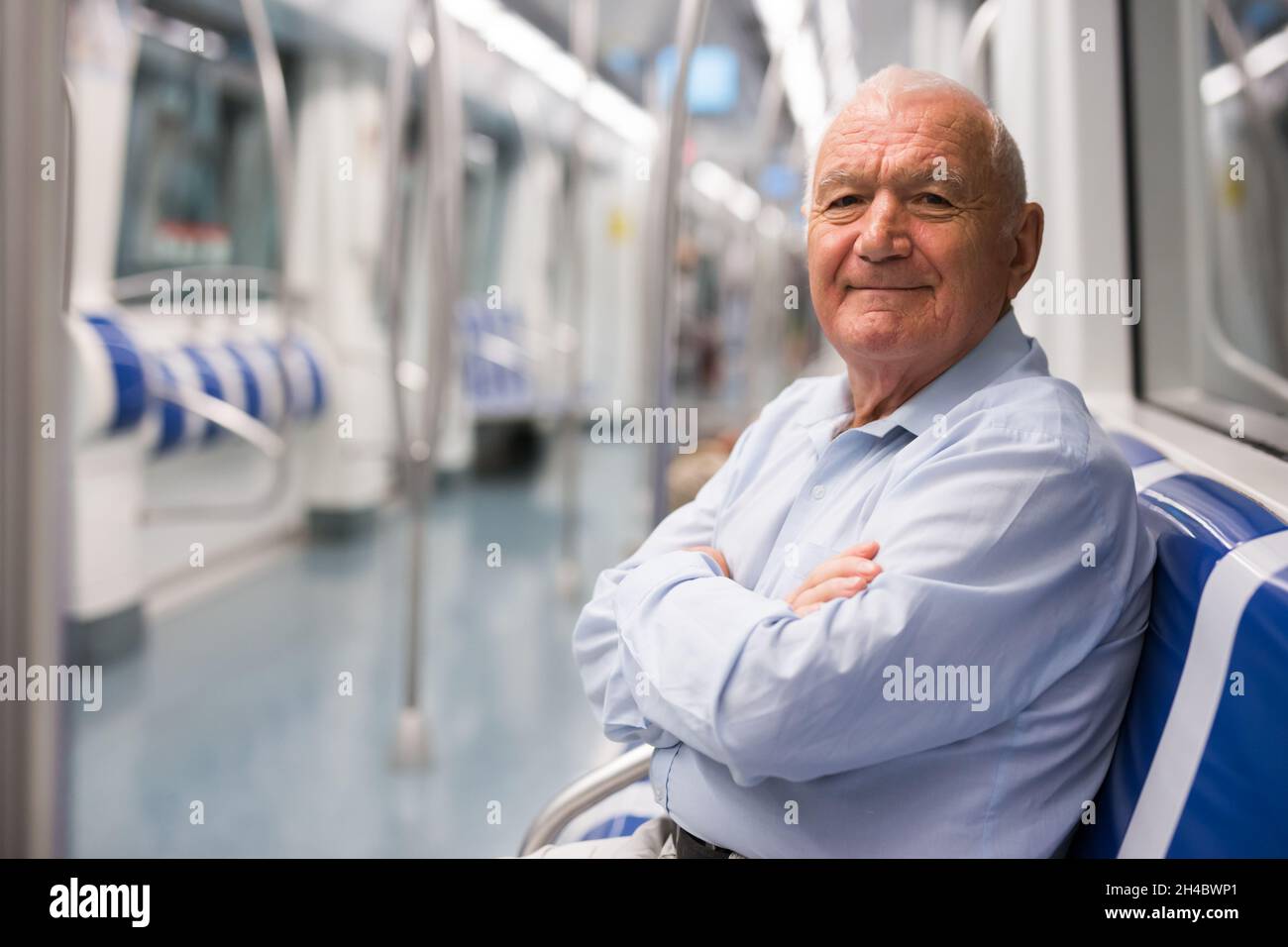 Senior man in metro train Stock Photo - Alamy