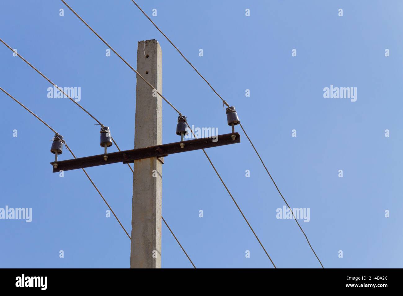 Wooden utility pole on a blue sky background Stock Photo - Alamy
