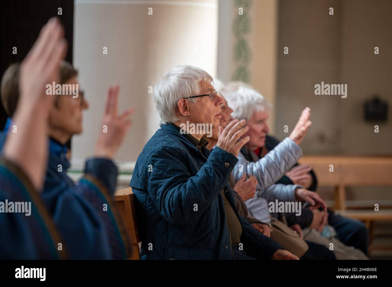 Trier, Germany. 24th Oct, 2021. Deaf faithful "pray" during a service ...