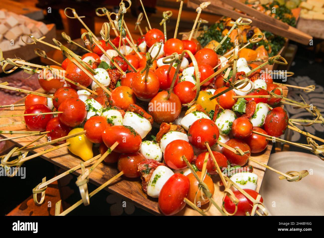 Mozzarella tomato appetizers are served at a diner buffet at an event ...