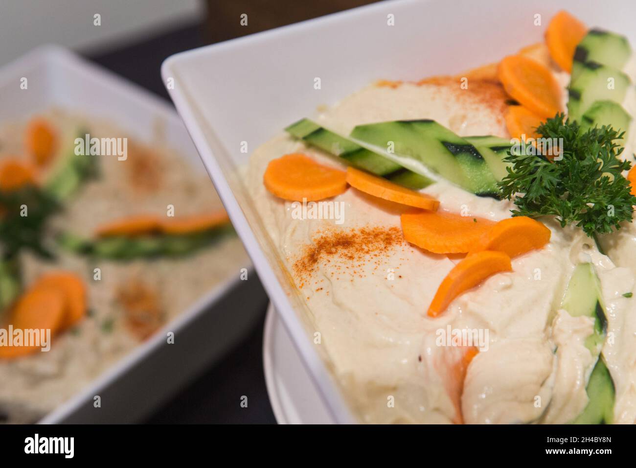 A bowl of hummus is served at a dinner buffet at an event Stock Photo ...