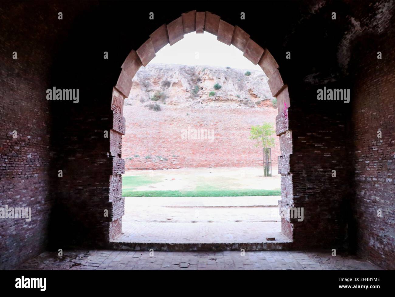 Sunlight coming through an arch made of brick Stock Photo - Alamy