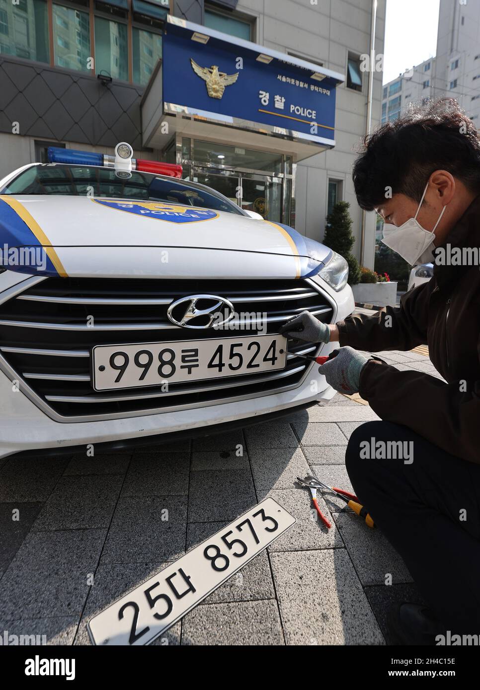 02nd Nov, 2021. New plates for emergency vehicles A policeman changes ...