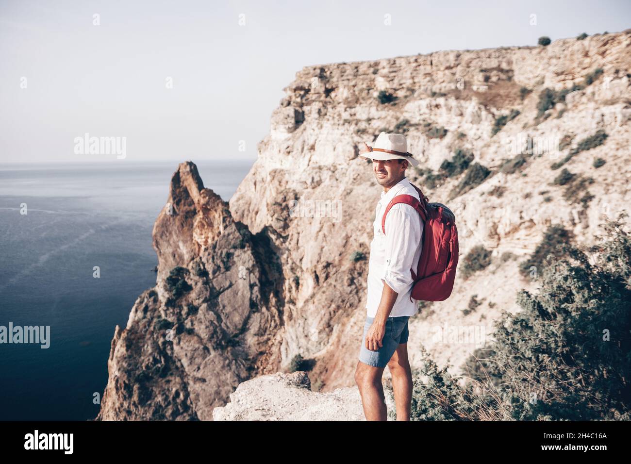 Digital nomad, man in the hat, a businessman with a laptop sits on the ...