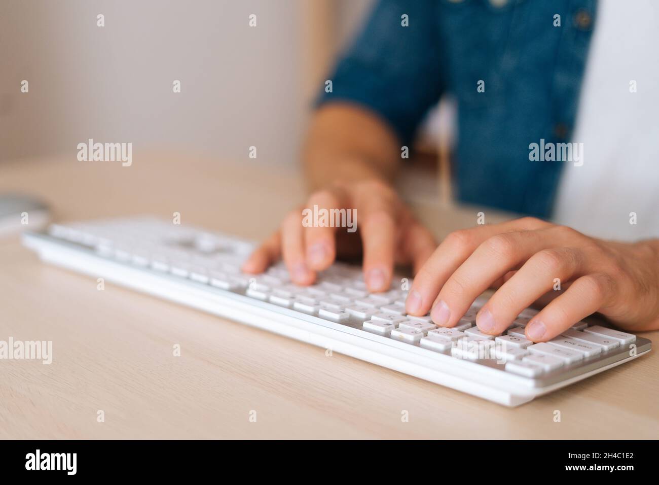 Close-up front view hands of unrecognizable young business man working typing online message ...