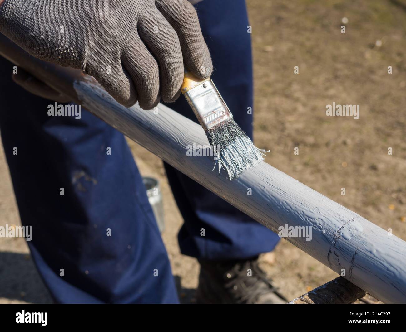 person primer painted metal pipe outdoors Stock Photo - Alamy