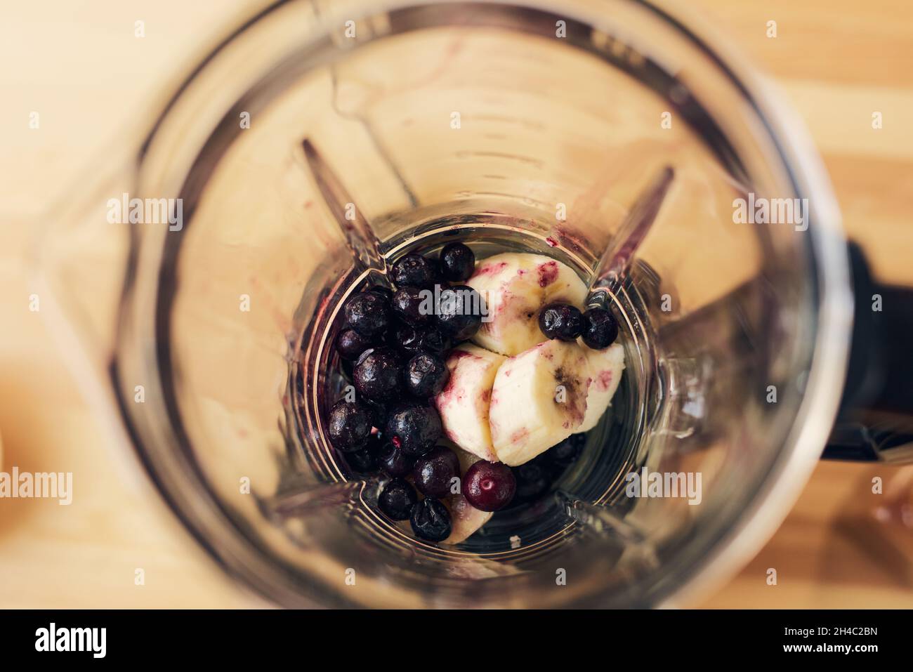 Fresh peeled and chopped banana and blueberries prepared for cooking ...