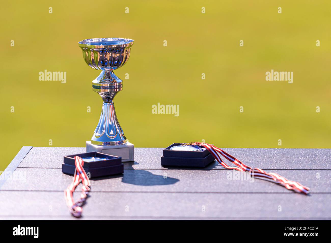 sports game prizes - cup and medals on a blurred background, closeup ...