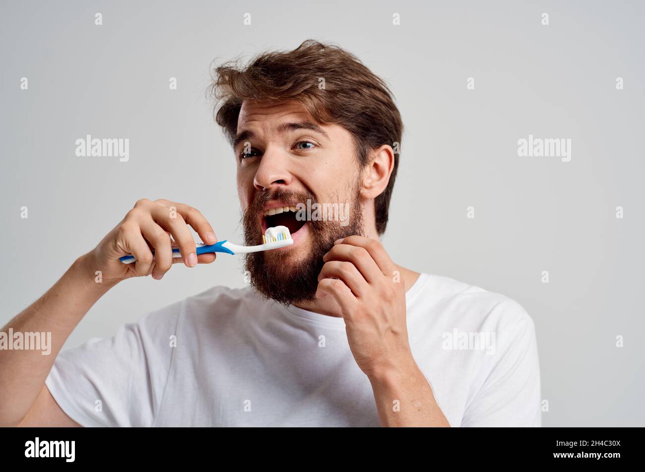 emotional man toothbrush in hand hygiene clean teeth isolated ...