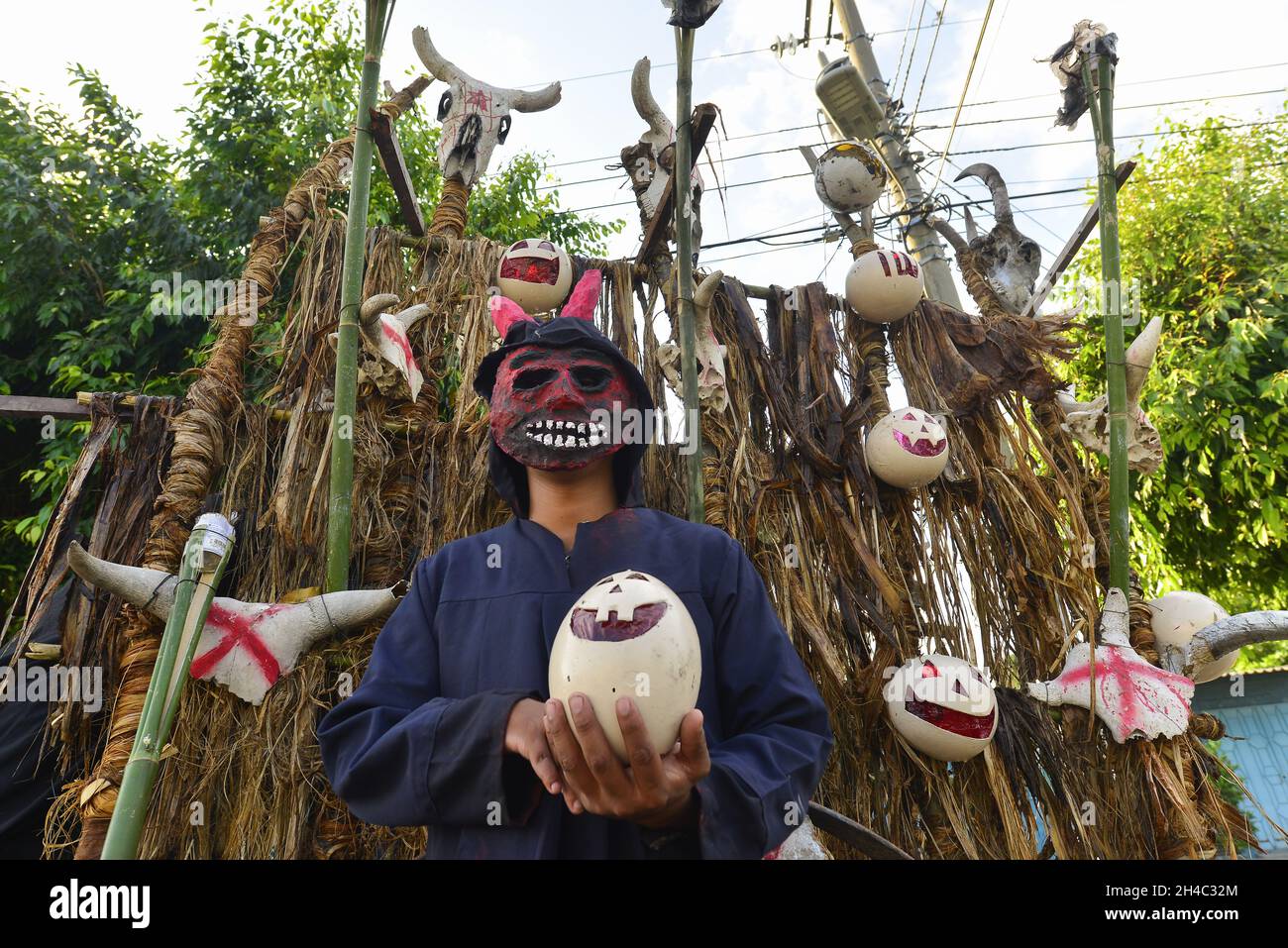 A reveler stands next to a cart with masks.Salvadorans celebrated ...