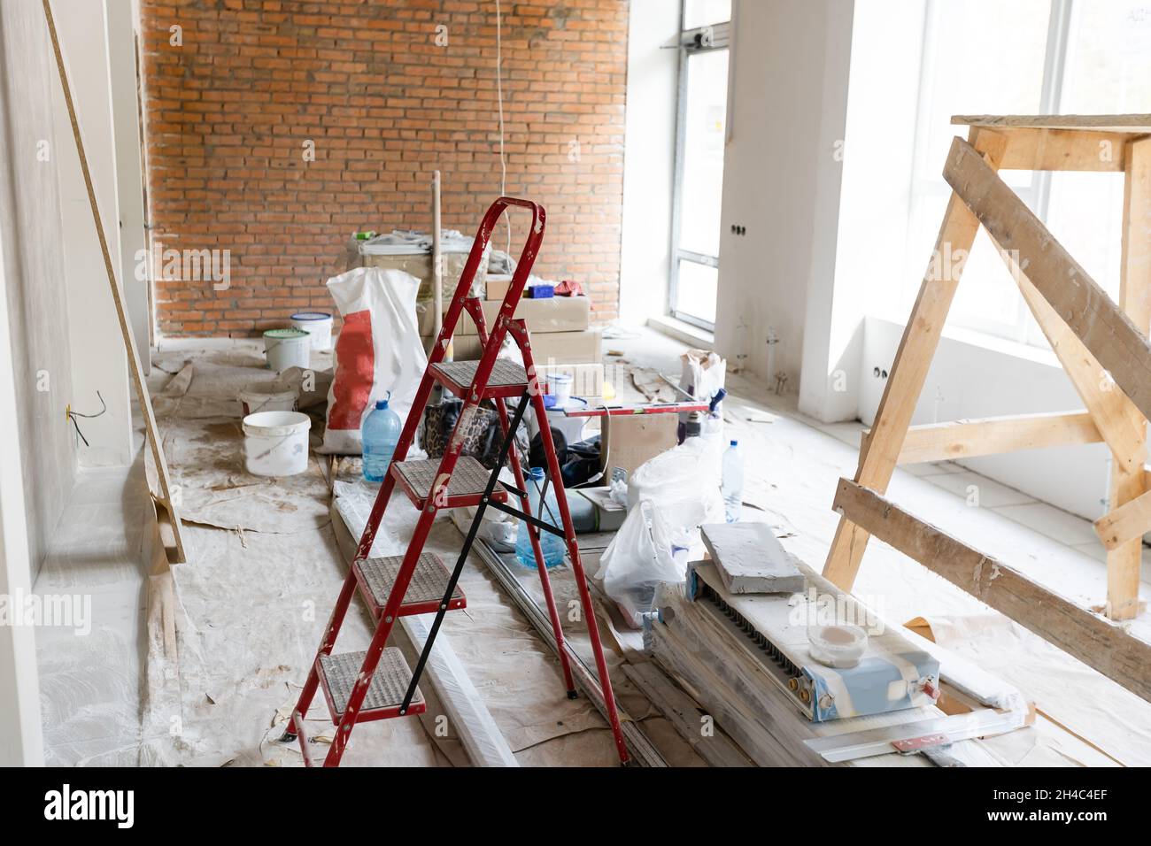 The wall of the building is covered with fresh plaster and surrounded ...