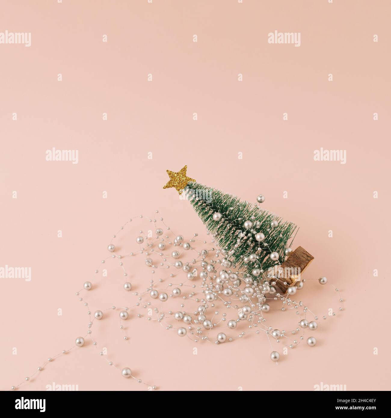 Layout with a Christmas tree on pink background Stock Photo - Alamy