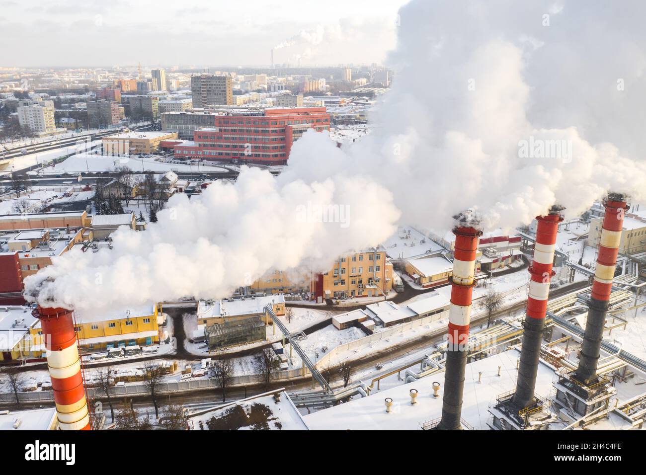 In the winter city, the factory's chimneys are smoking. The concept of ...