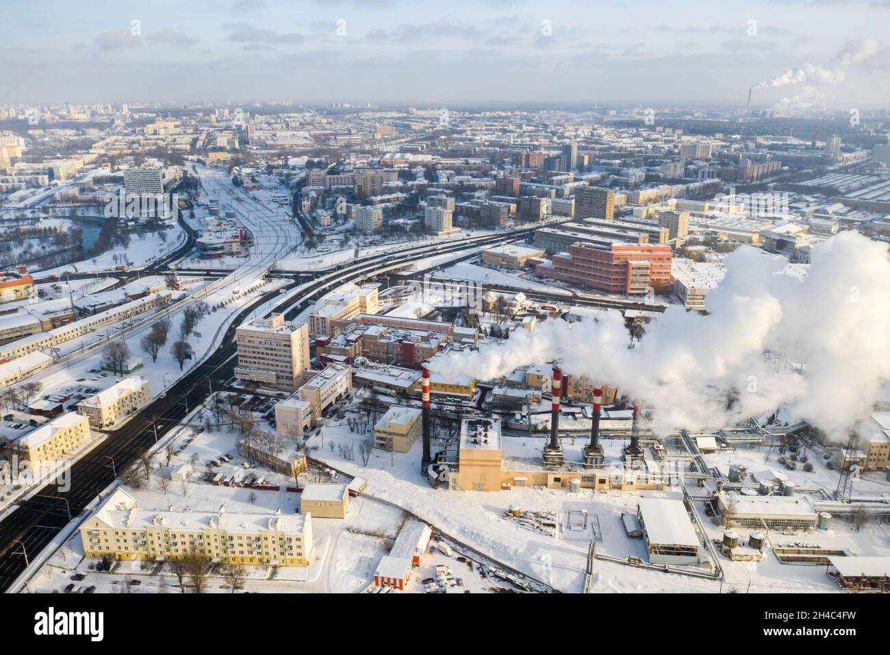 In the winter city, the factory's chimneys are smoking. The concept of ...