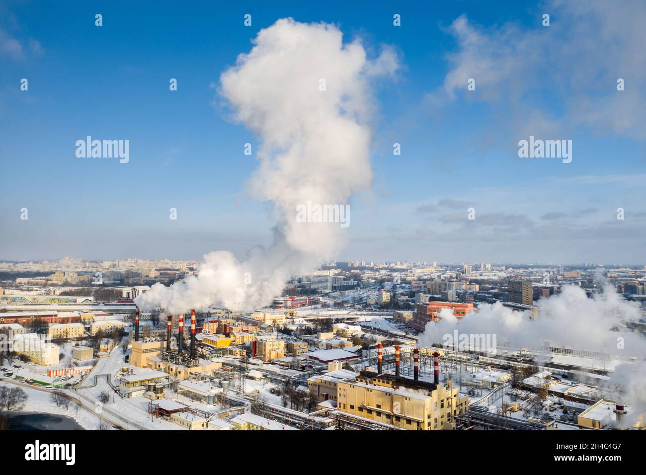 In the winter city, the factory's chimneys are smoking. The concept of ...