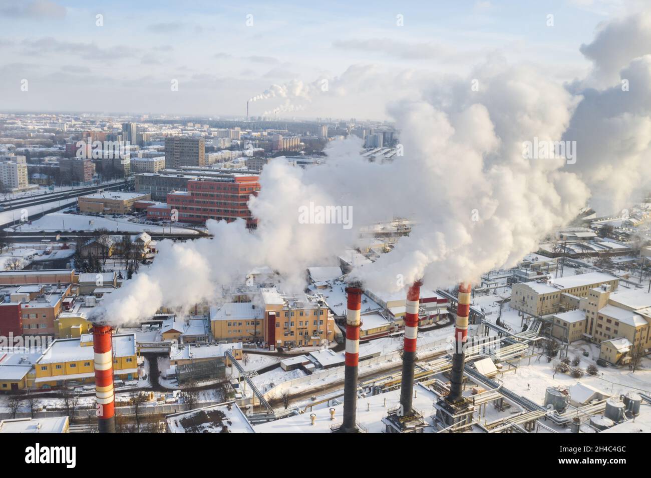 In the winter city, the factory's chimneys are smoking. The concept of ...