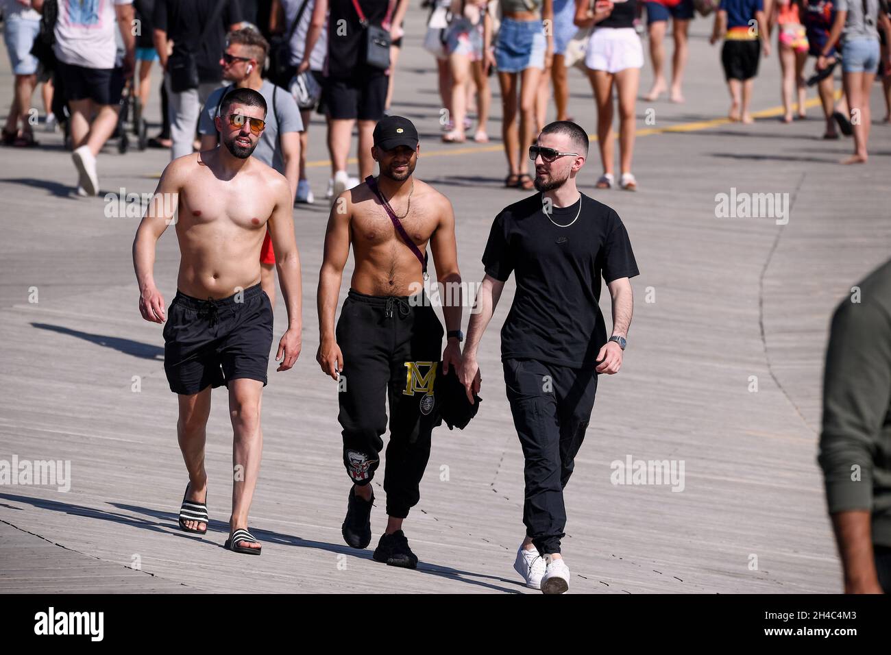 Melbourne, Australia, 2 November, 2021. Three men walk along the ...