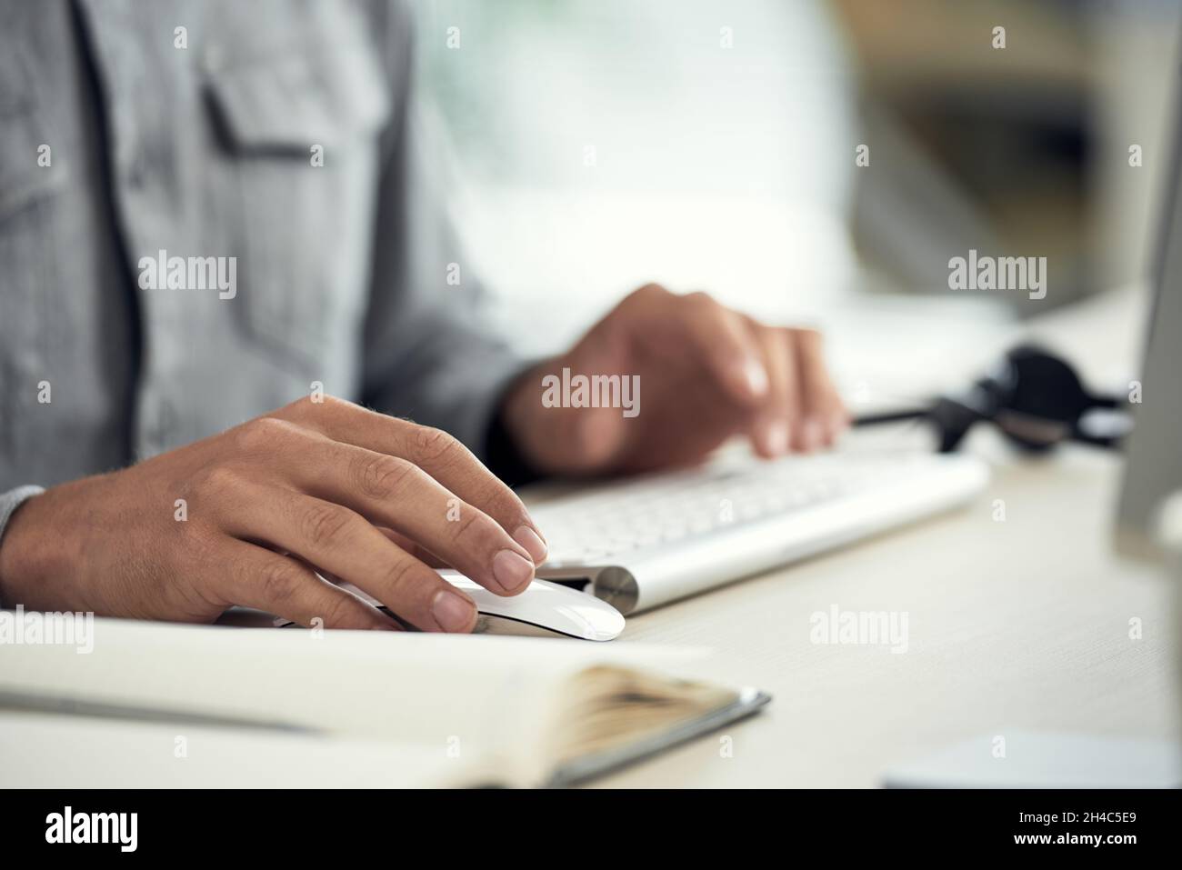 Close-up of unrecognizable office worker using computer mouse and ...