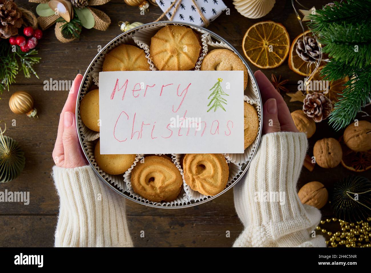 Biscuits in box, note with merry christmas greetings. New year ...