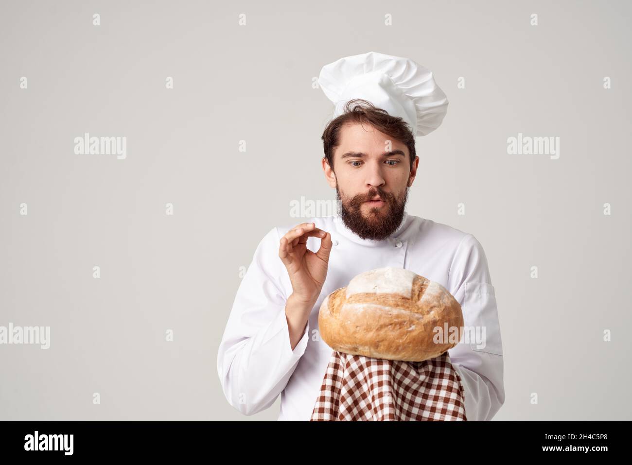 male cook with bread in hand Professional emotions Stock Photo - Alamy
