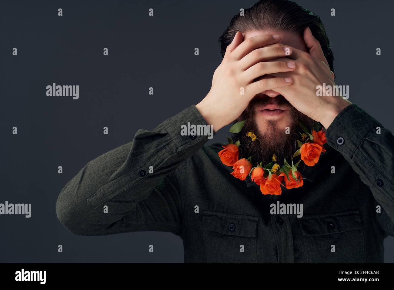 bearded man hairstyle fashion flowers emotions dark background Stock ...