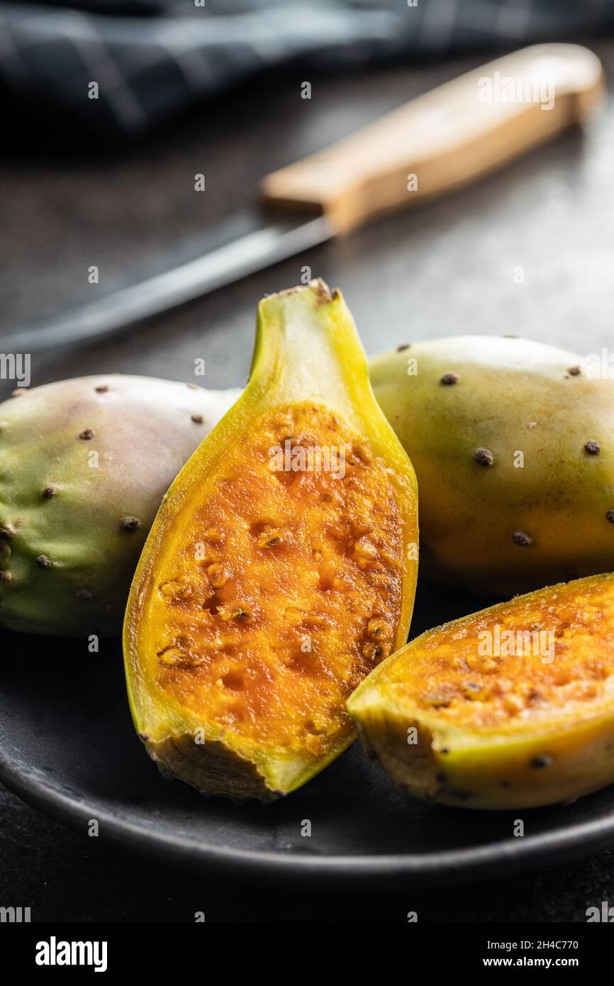 Raw prickly pears. Opuntia or indian fig cactus on plate Stock Photo ...