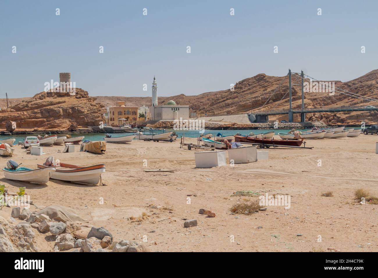 Fishing boats in Sur, Oman. Watchtower in Ayjah village in the ...