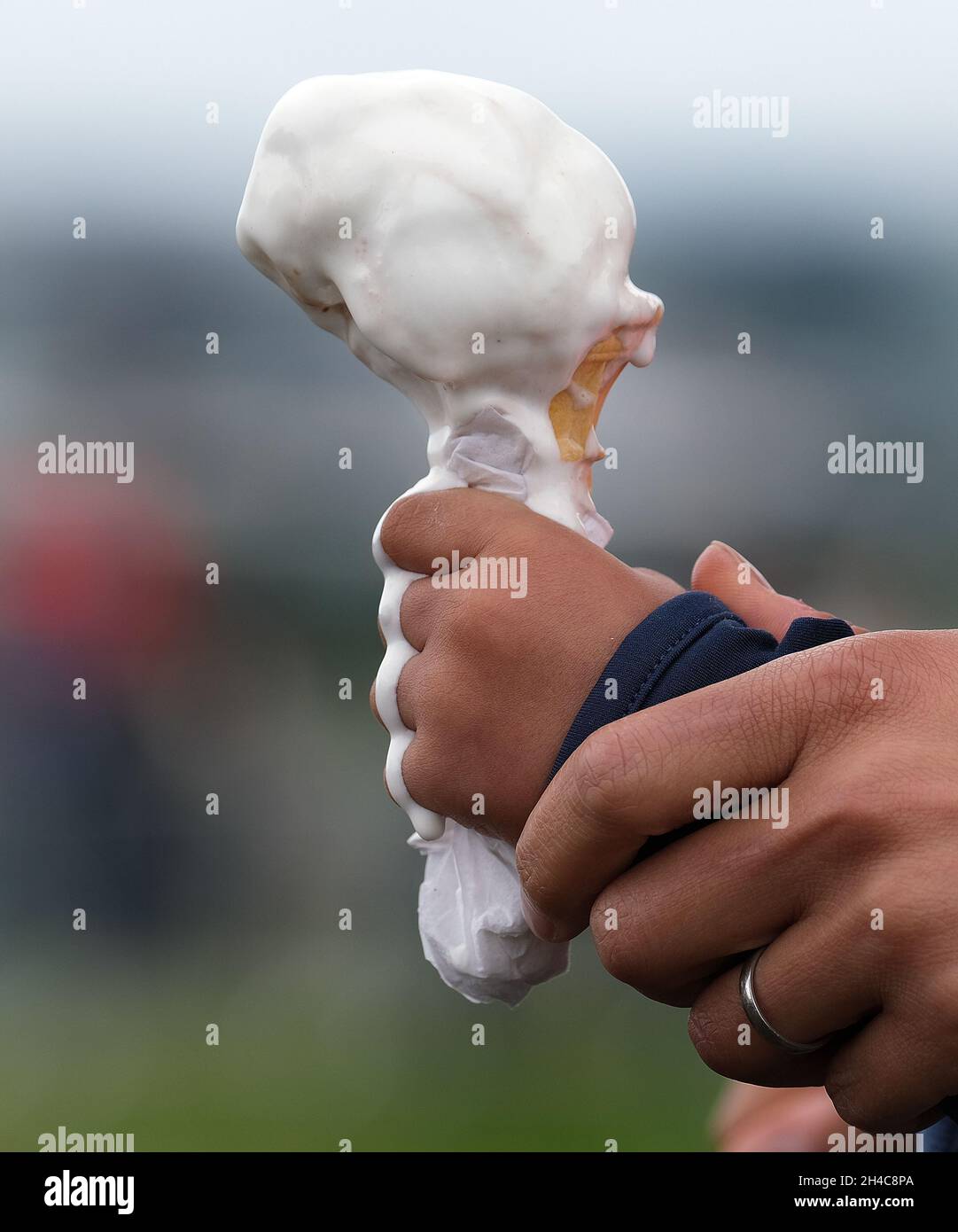 Melting ice cream cornet in child's hand Stock Photo - Alamy