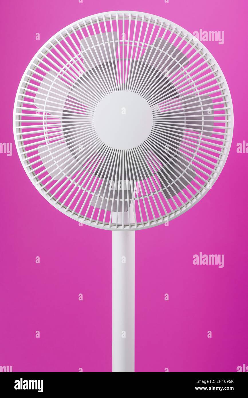 A high-tech white electric fan with a modern design for cooling the ...